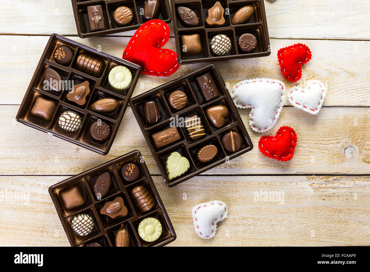Assorted chocolates on wood table Stock Photo - Alamy
