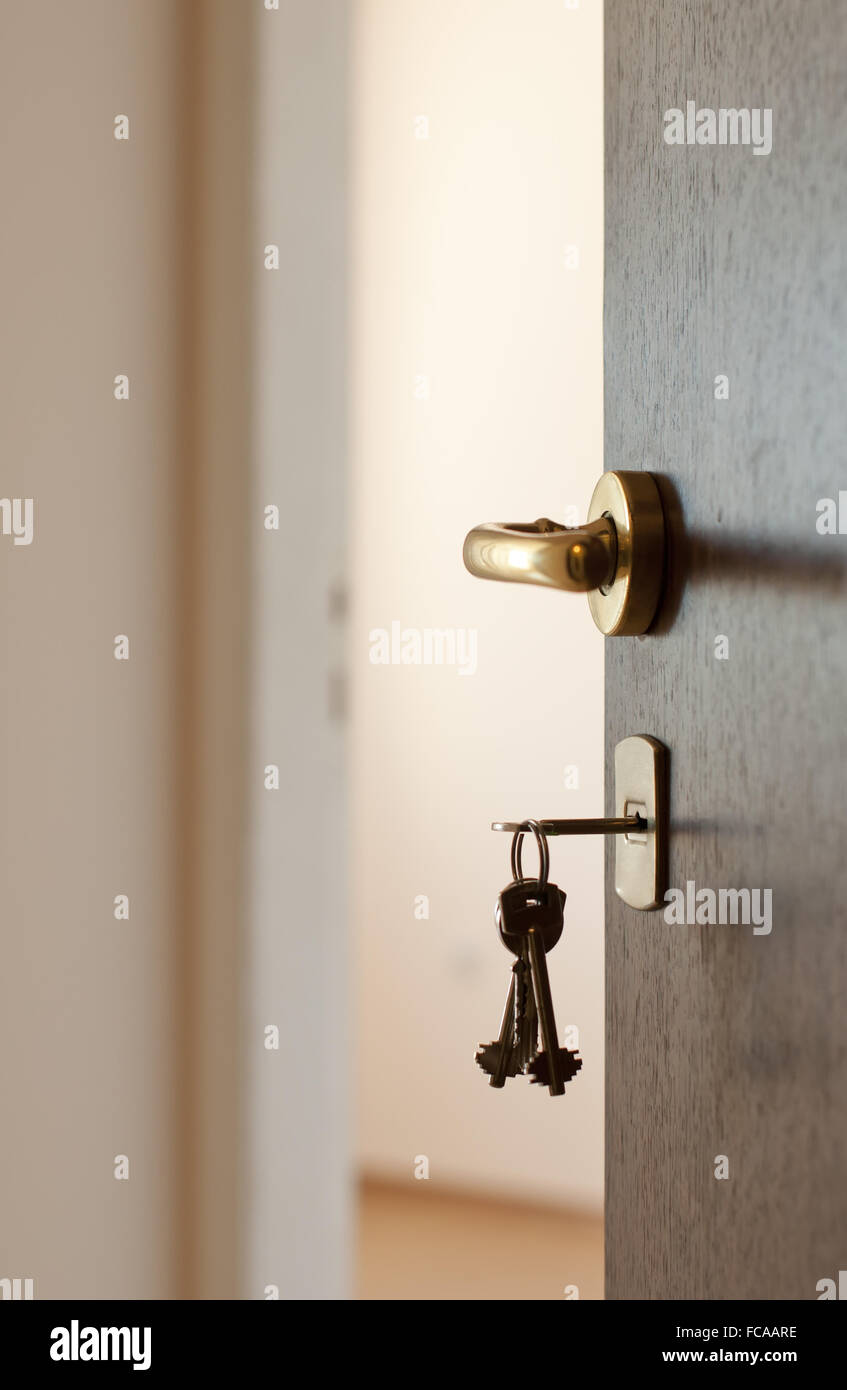 Open door with keys Stock Photo - Alamy