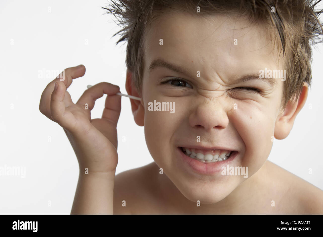 Boy cleans his ear Stock Photo - Alamy
