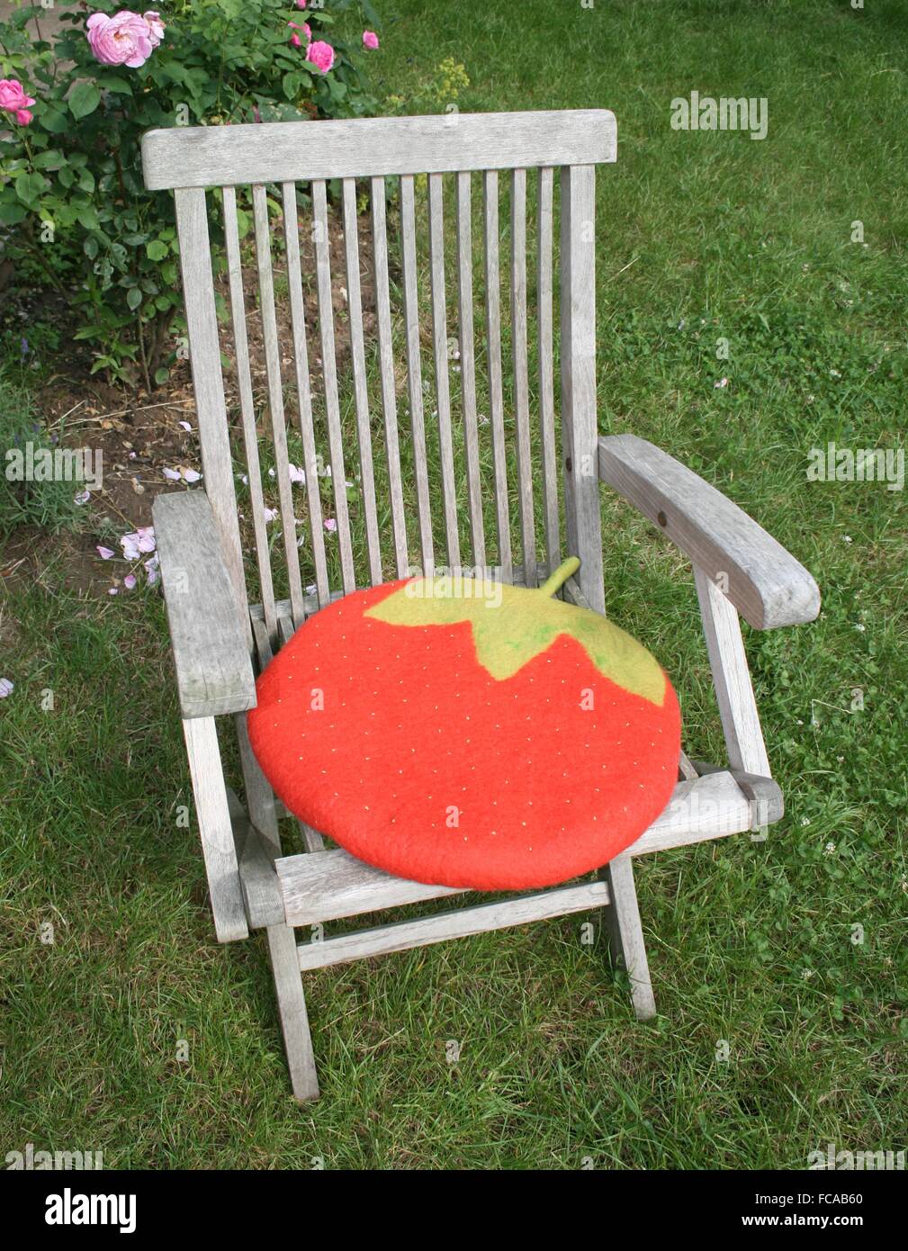 Garden chair with strawberry cushion Stock Photo - Alamy