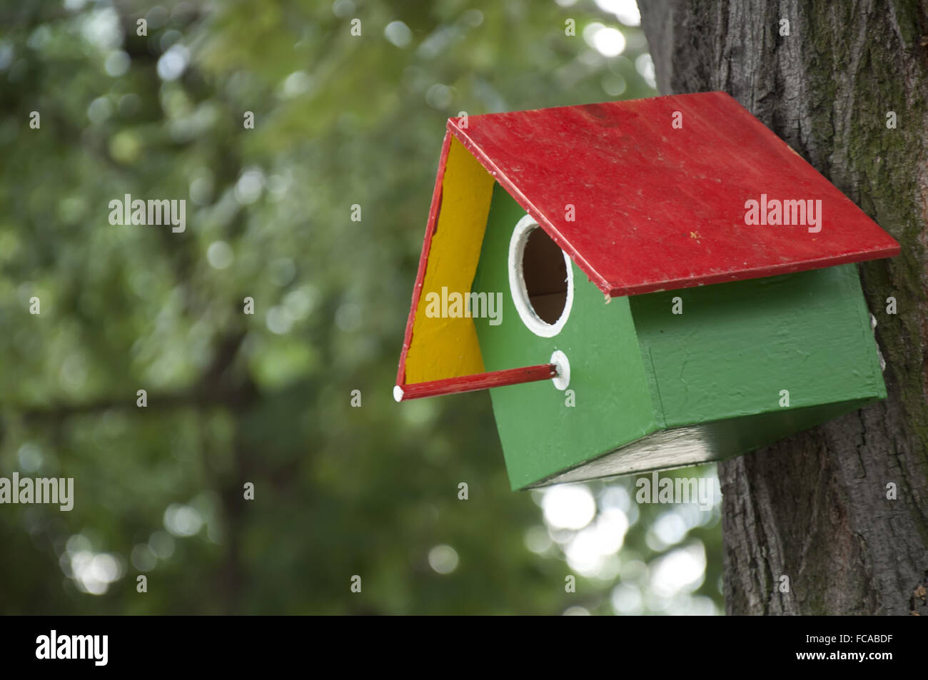 Home-made bright colored bird house Stock Photo - Alamy