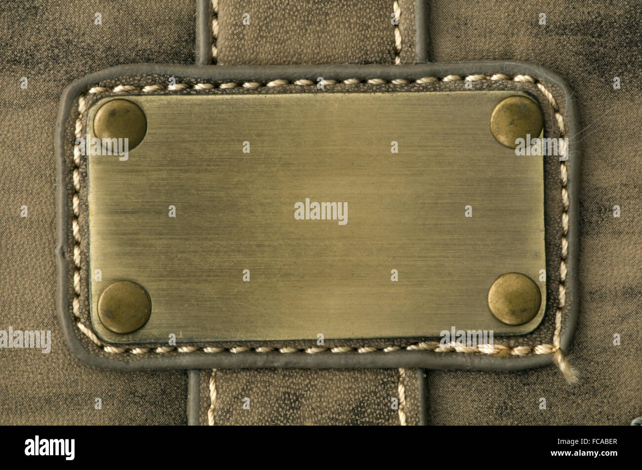 Textile patch sewn on fabric Stock Photo - Alamy