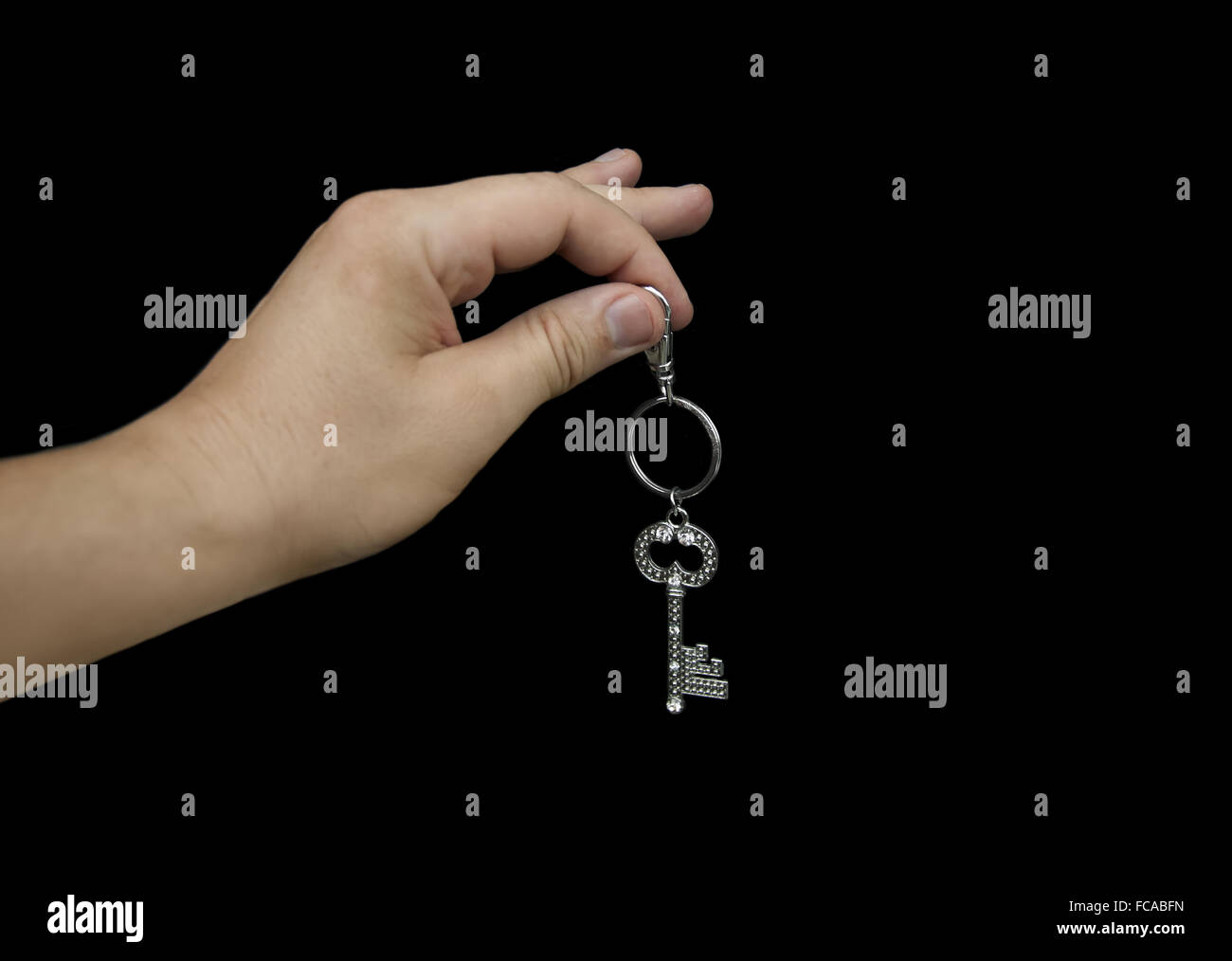 Hand holding key Stock Photo - Alamy