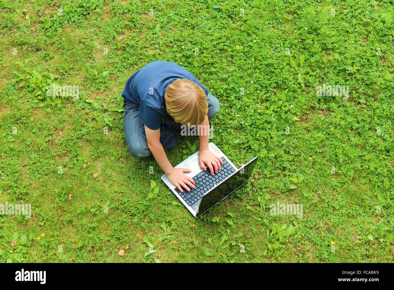 Child behind a notebook Stock Photo - Alamy