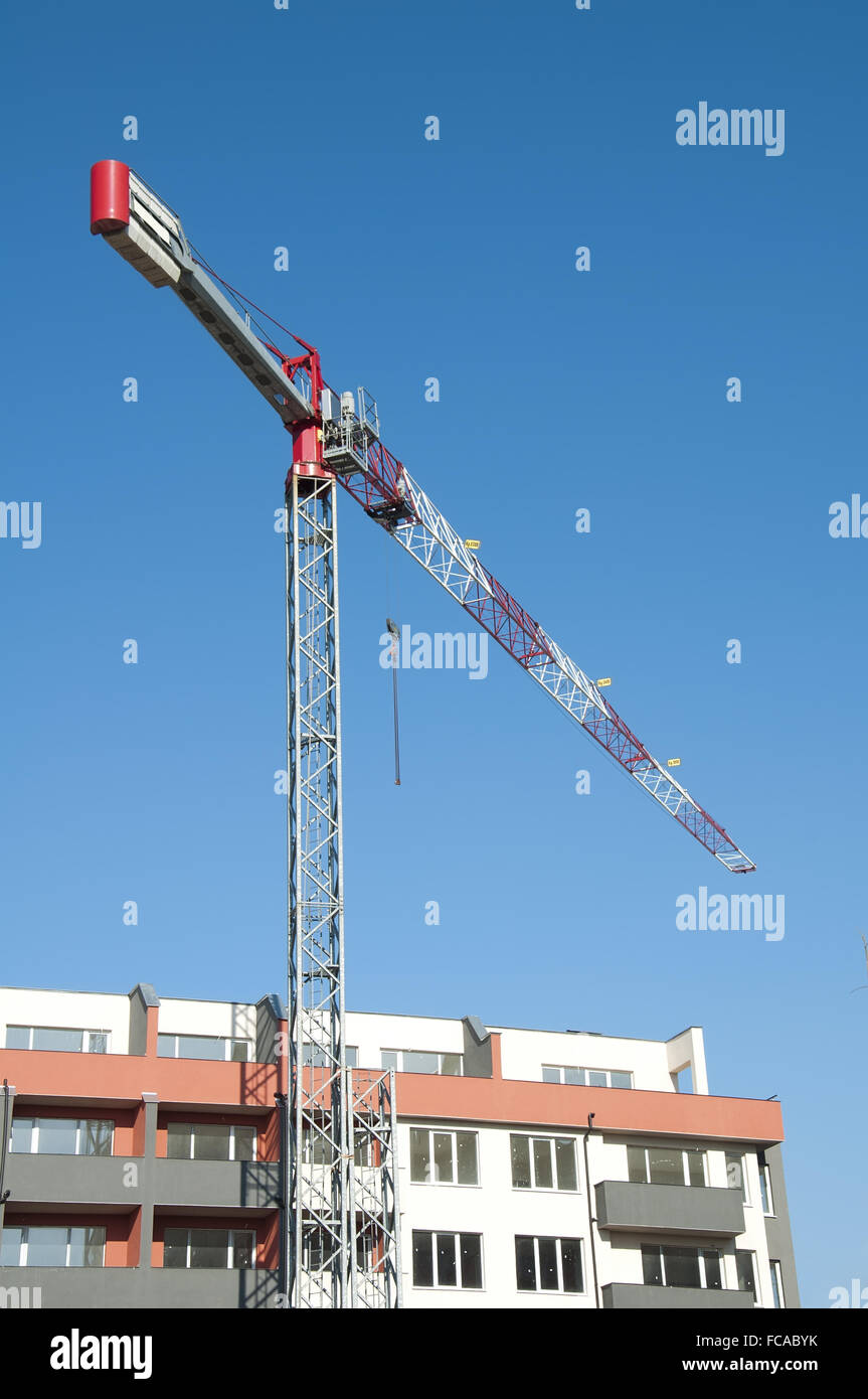 New colored building and crane Stock Photo - Alamy