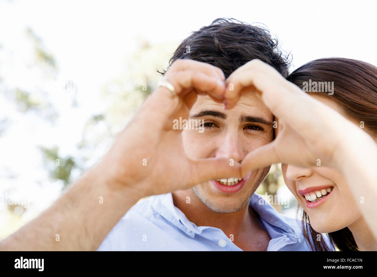 Young couple in the park and heart symbol Stock Photo - Alamy
