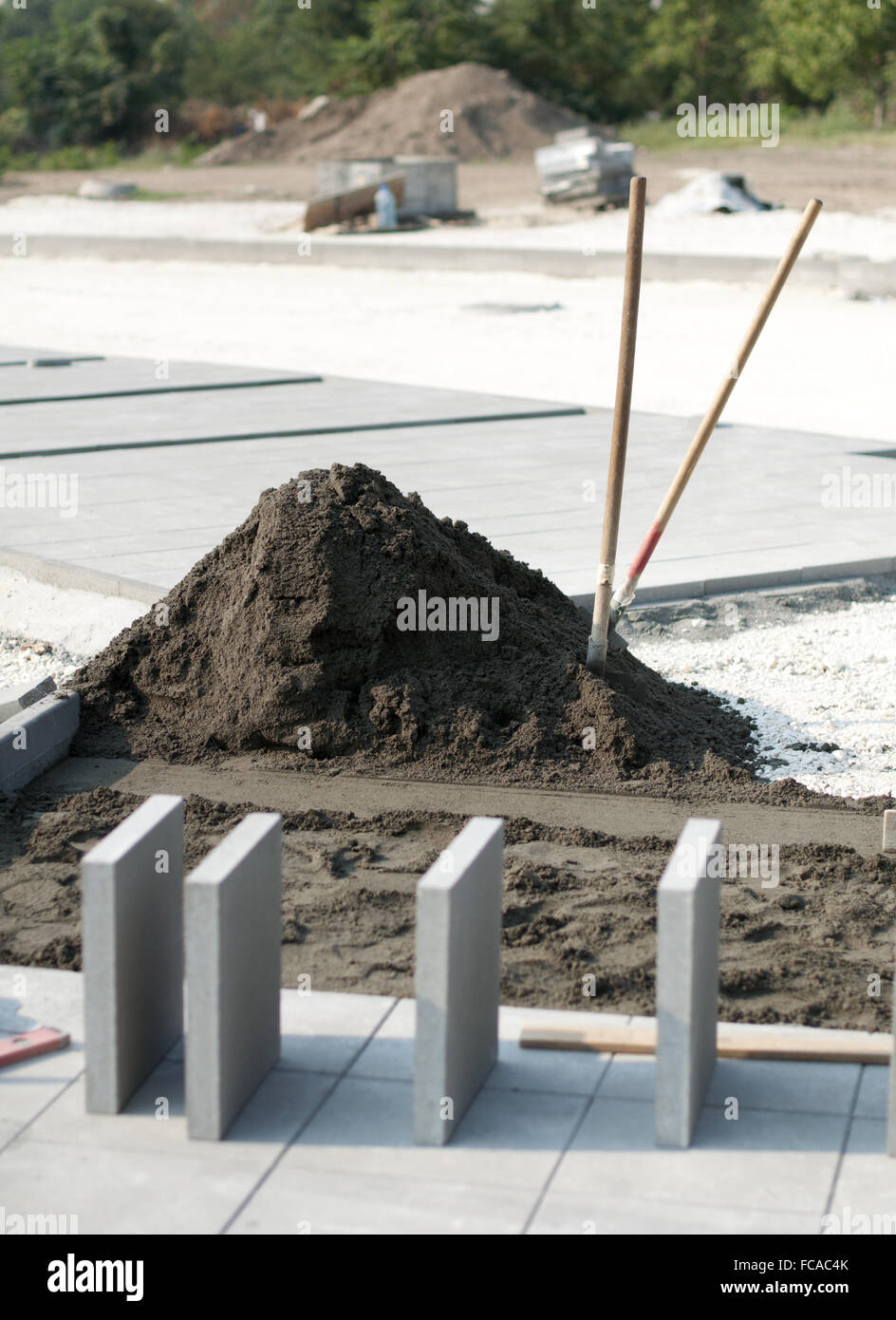 Tiling of pavement and sand pile Stock Photo - Alamy
