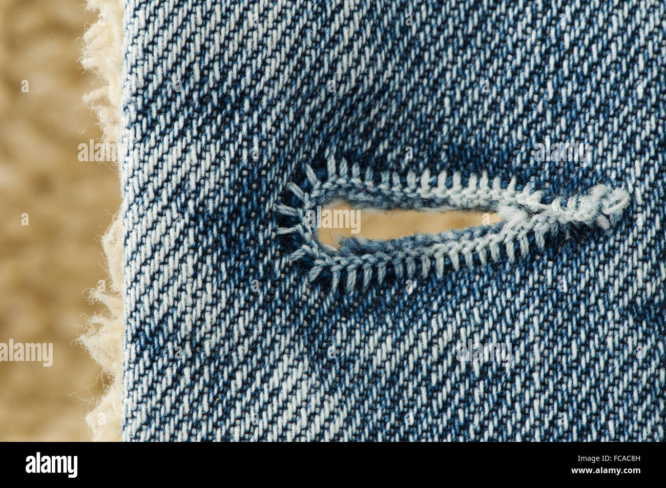 Buttonhole of jeans cloth Stock Photo - Alamy