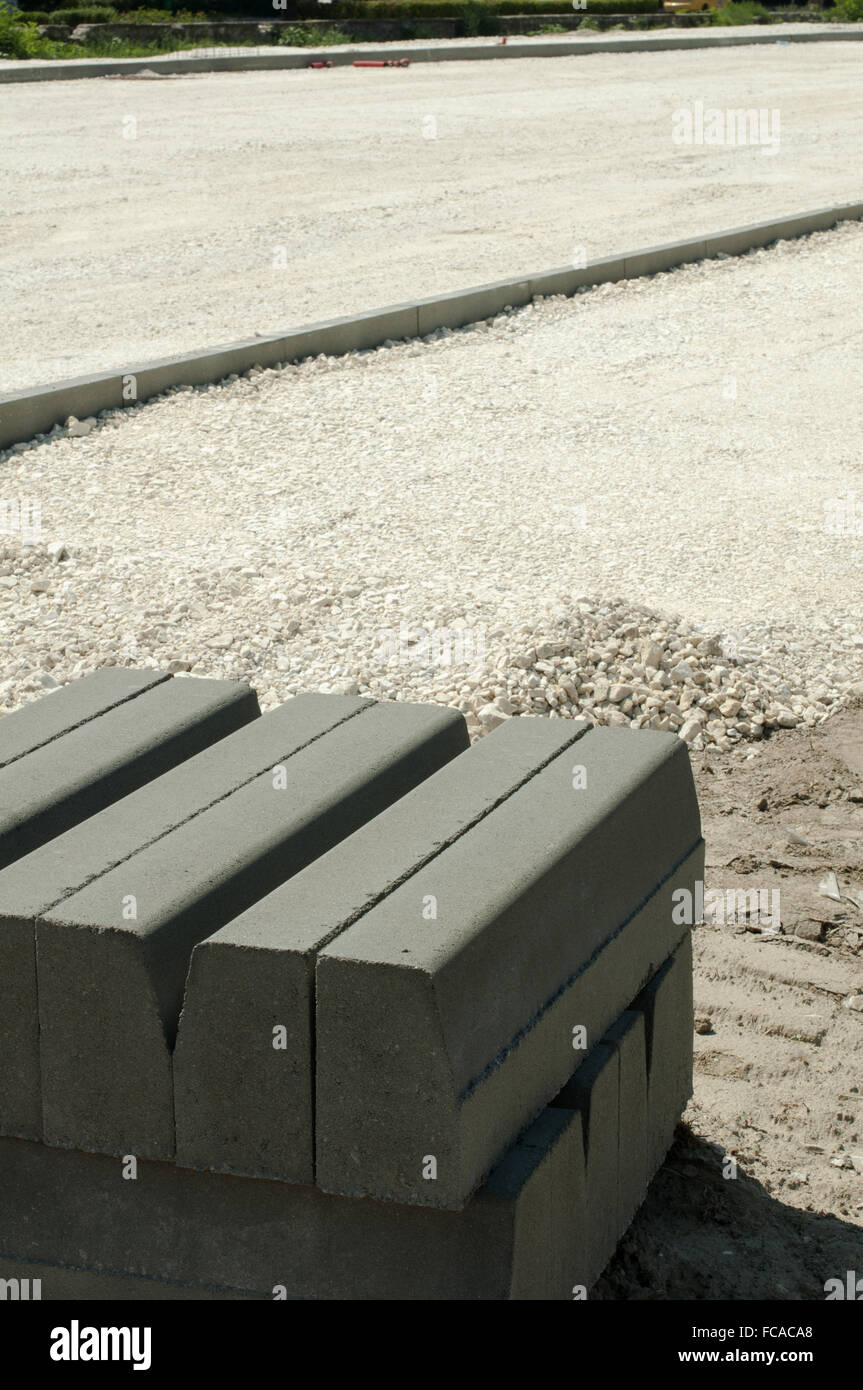 Curb and gravel on the road in repair Stock Photo - Alamy