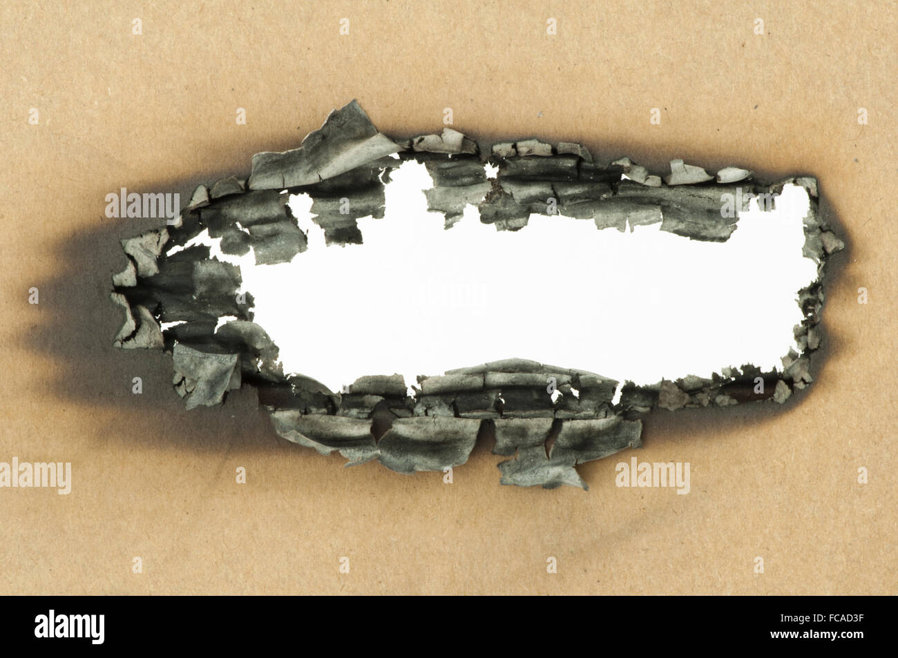 Burned paper and hole Stock Photo - Alamy