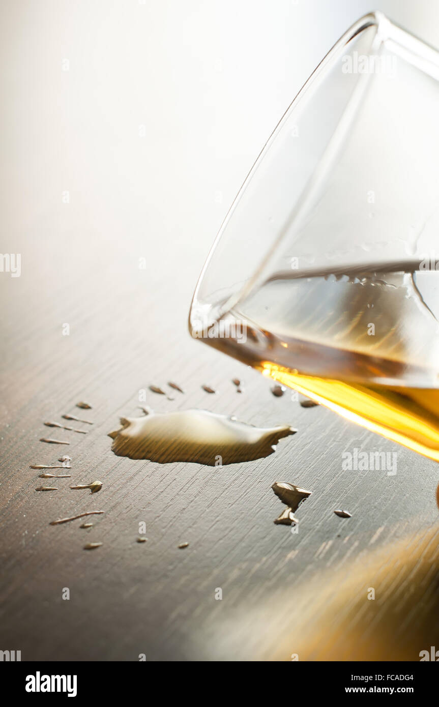 Glass with whiskey and drops on the table Stock Photo - Alamy