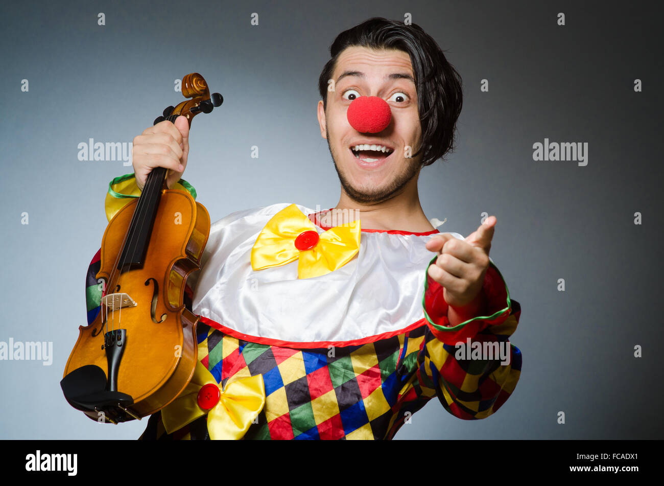 Funny violin clown player in musical concept Stock Photo - Alamy