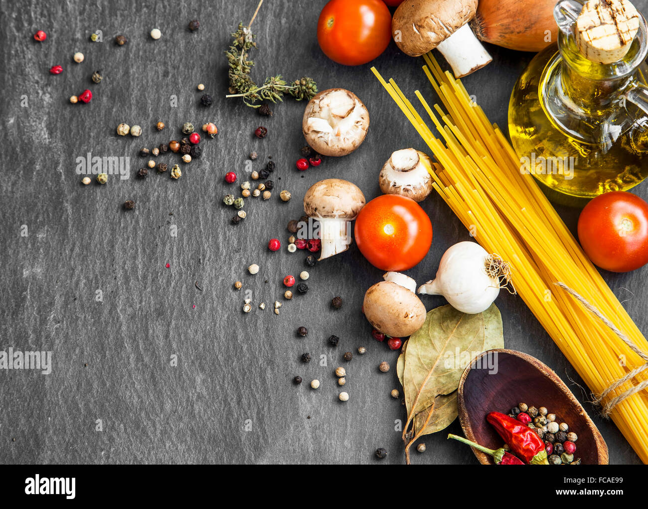 Italian meal ingredients with pasta,spices,tomatoes,olive oil,mushrooms ...