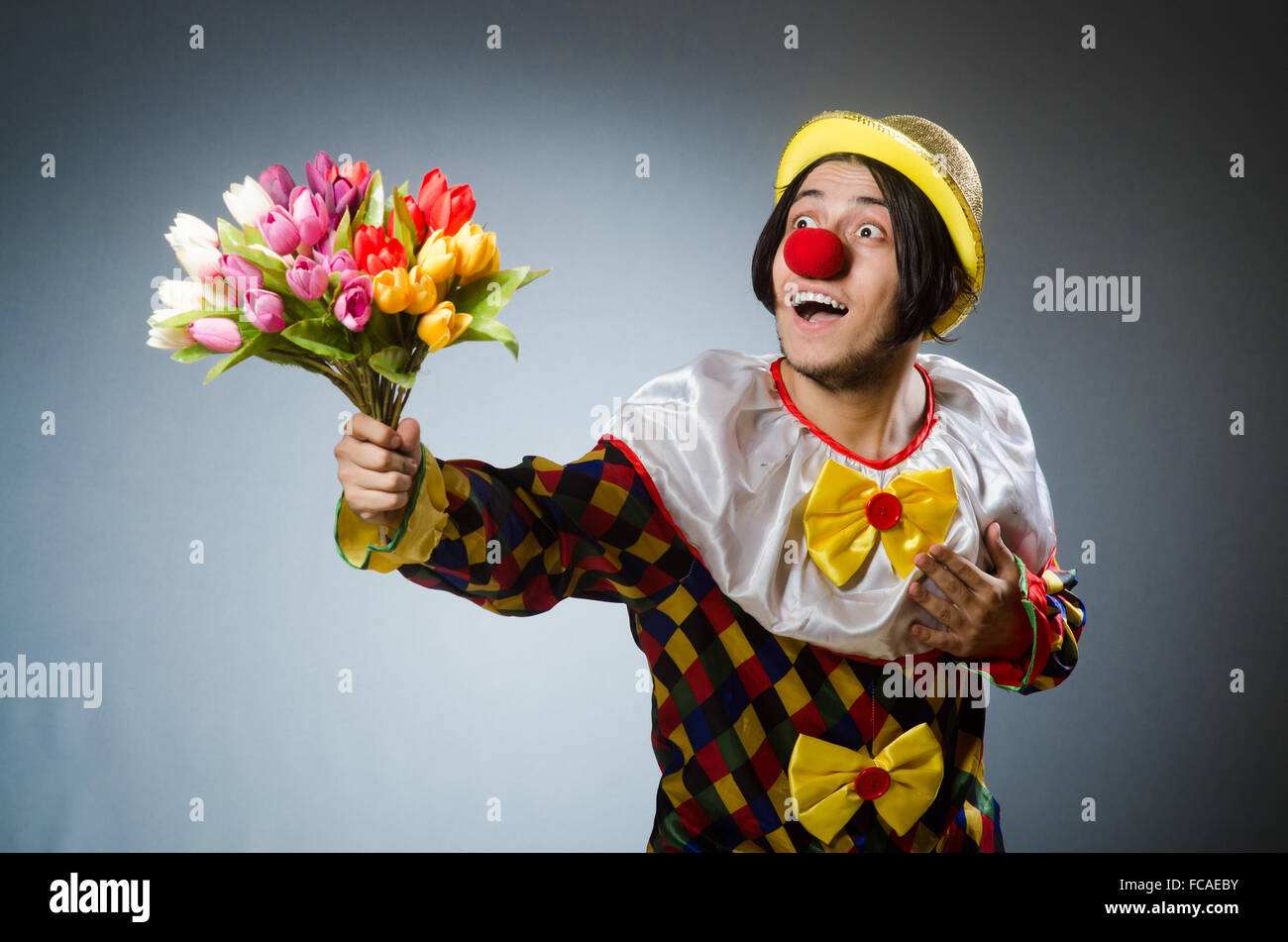 The clown with tulip flowers in funny concept Stock Photo - Alamy