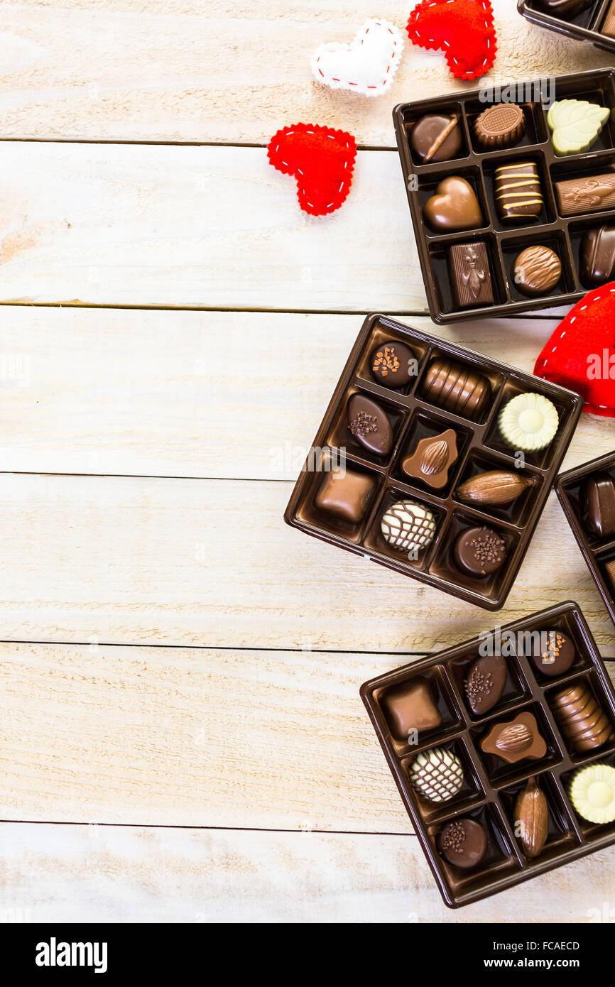 Assorted chocolates on wood table Stock Photo - Alamy