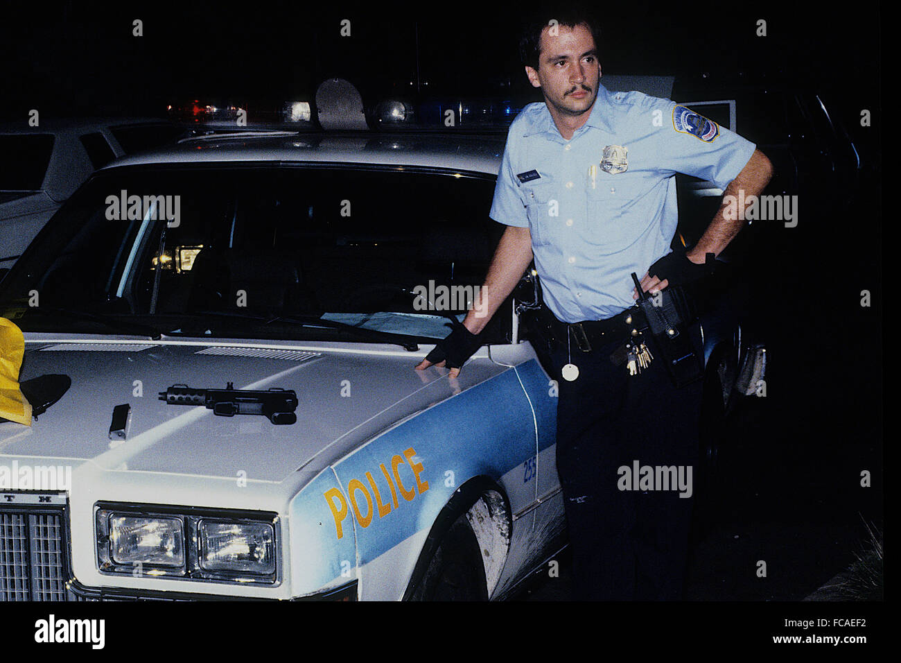 Washington, DC. USA, 1989 DC. Police officer displays the machine gun ...