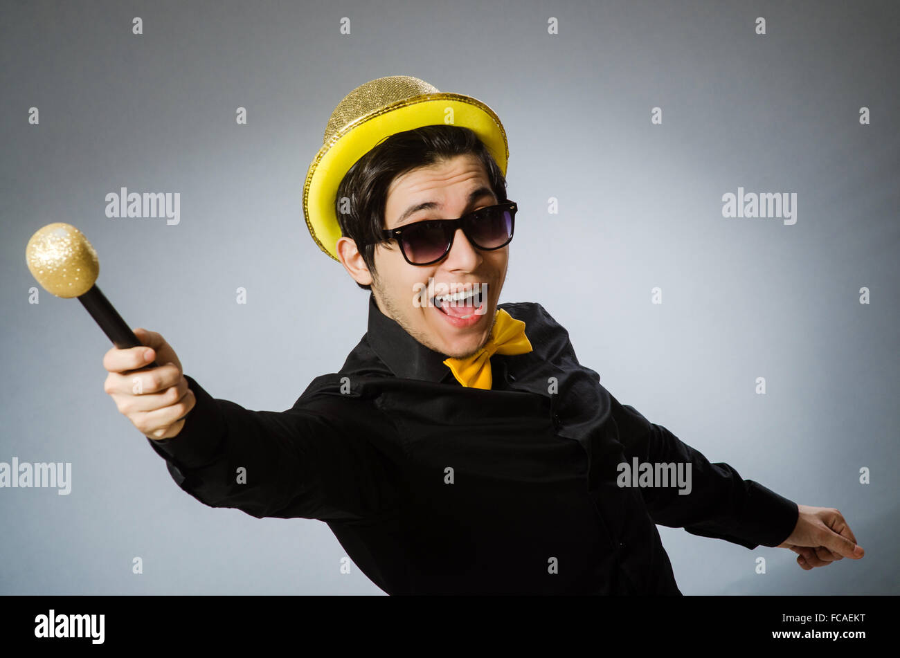 The funny man with mic in karaoke concept Stock Photo - Alamy
