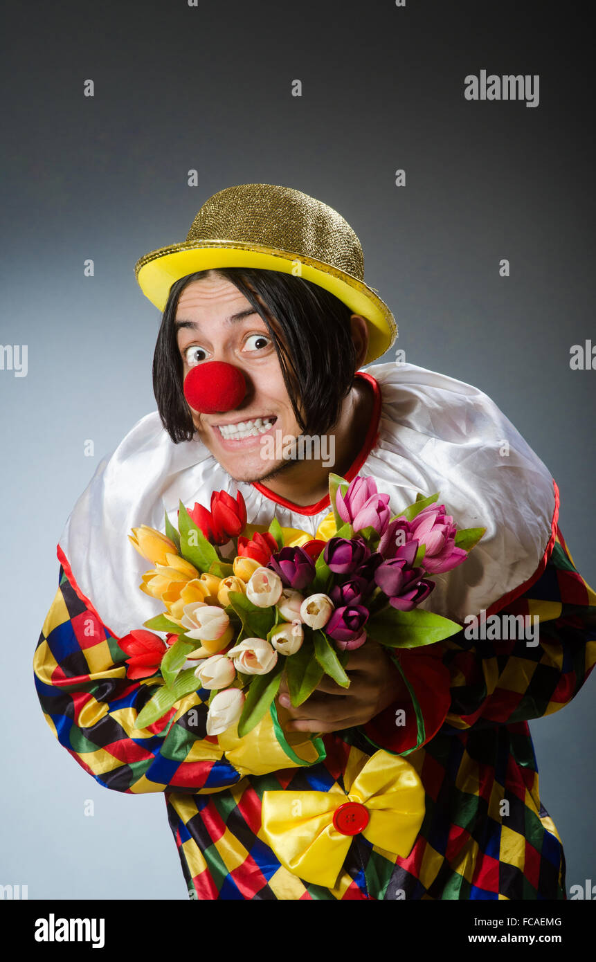 Clown with tulip flowers in funny concept Stock Photo - Alamy