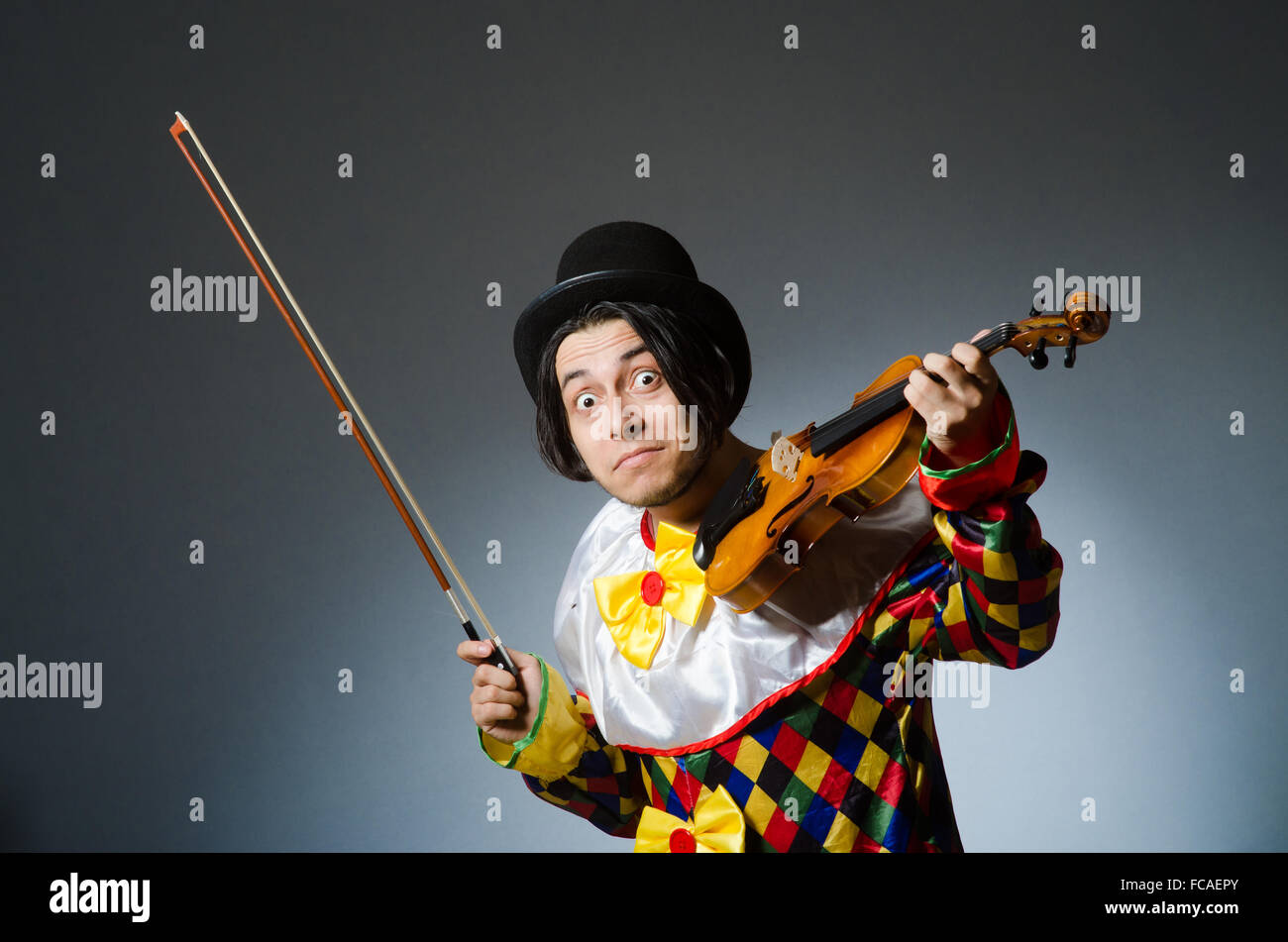 Funny violin clown player in musical concept Stock Photo - Alamy