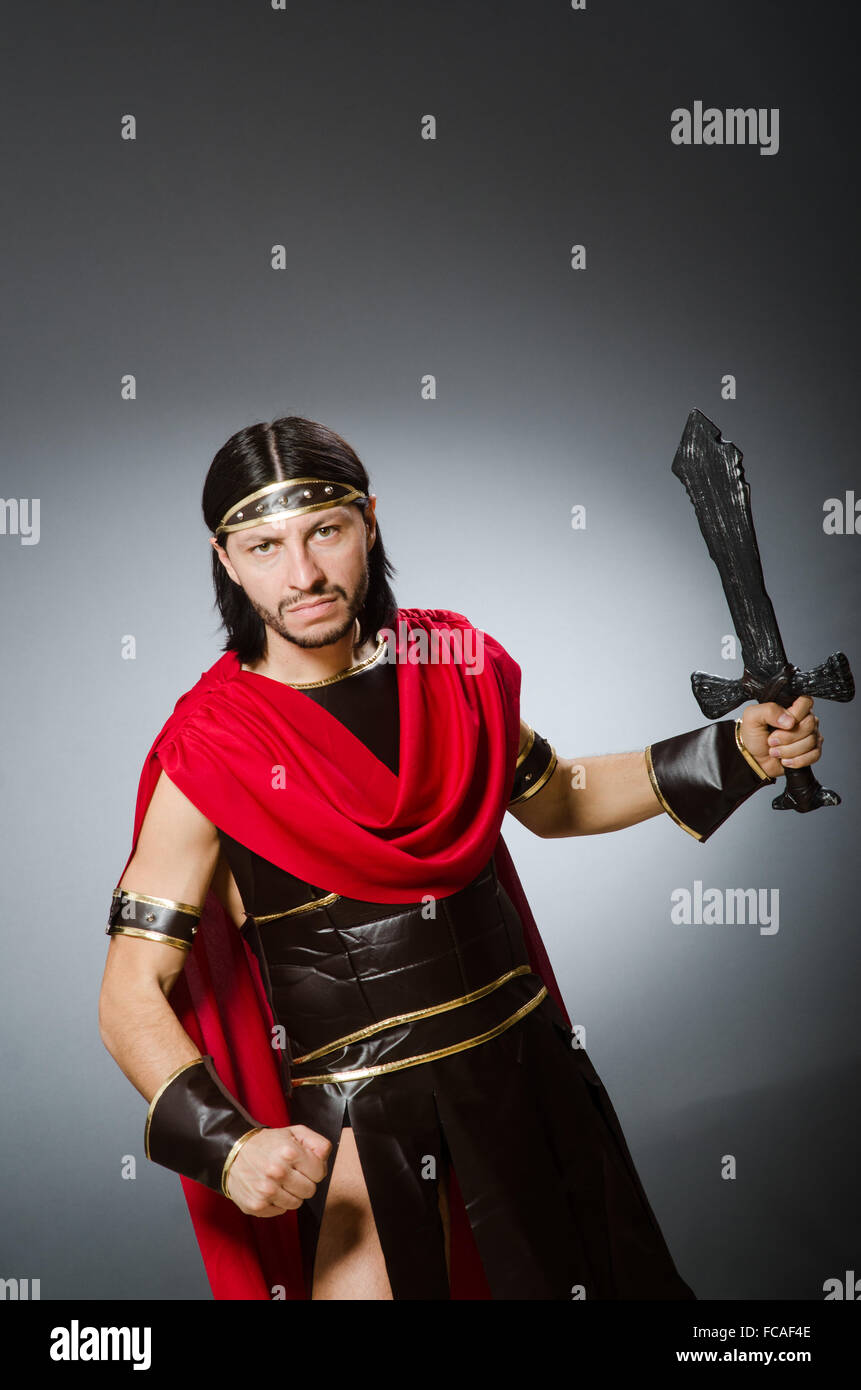 Roman warrior with sword against background Stock Photo - Alamy