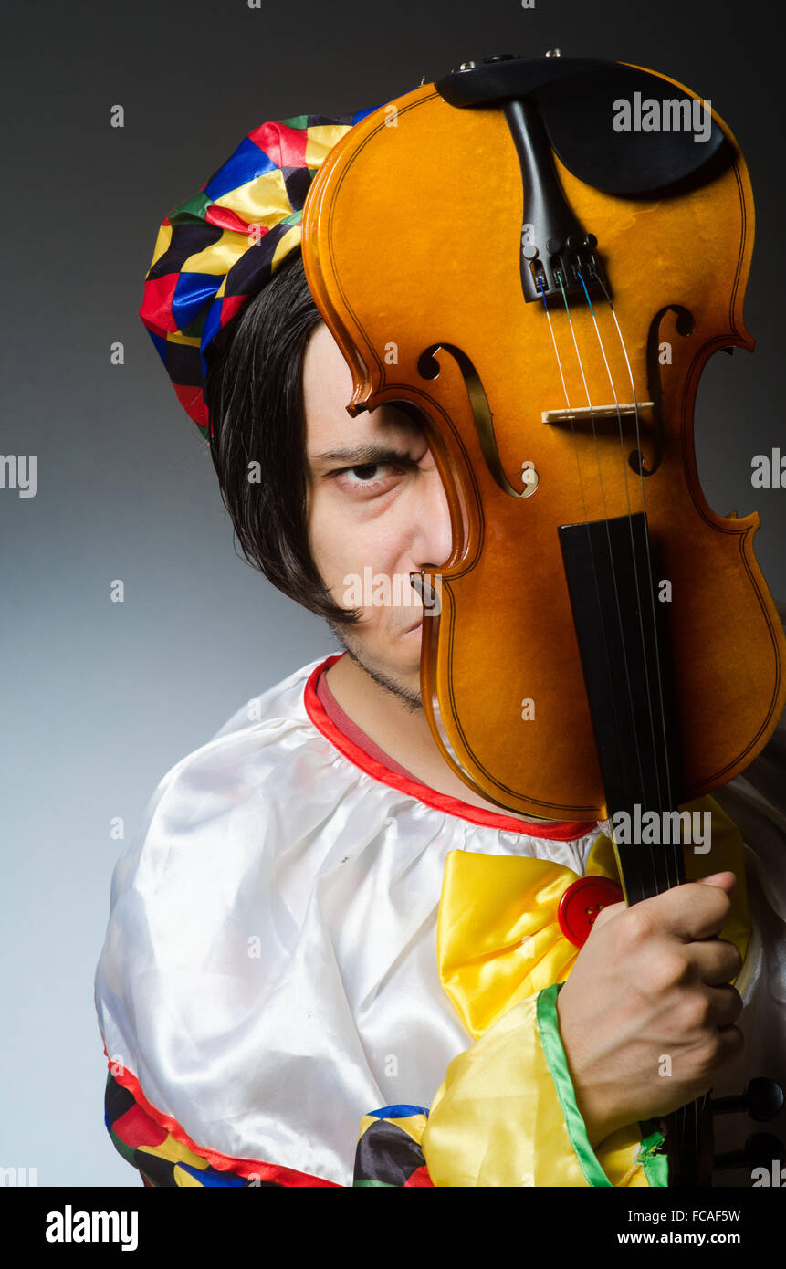 Funny violin clown player in musical concept Stock Photo - Alamy