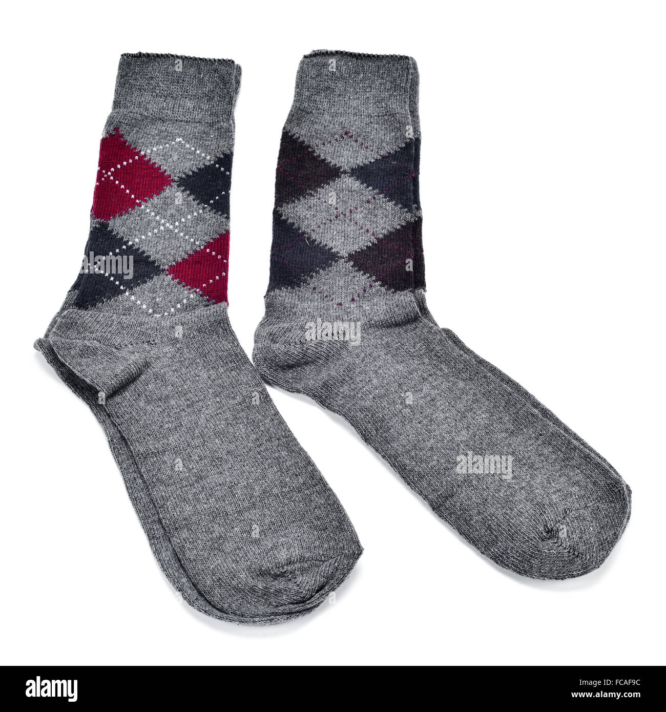 two pairs of argyle patterned socks in different colors on a white ...