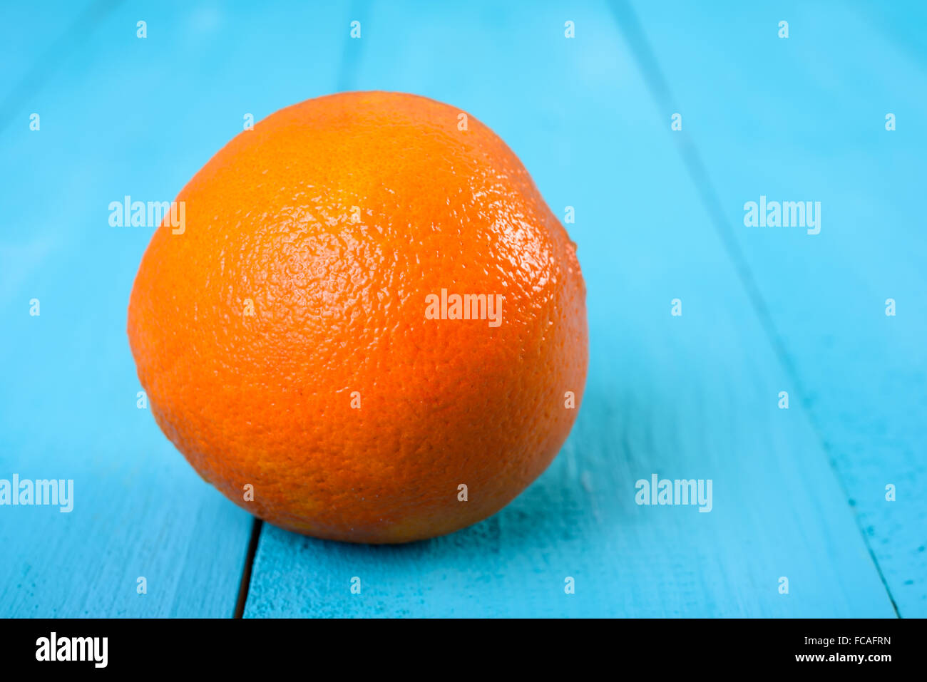 Orange Fruit On Turquoise Background Stock Photo - Alamy