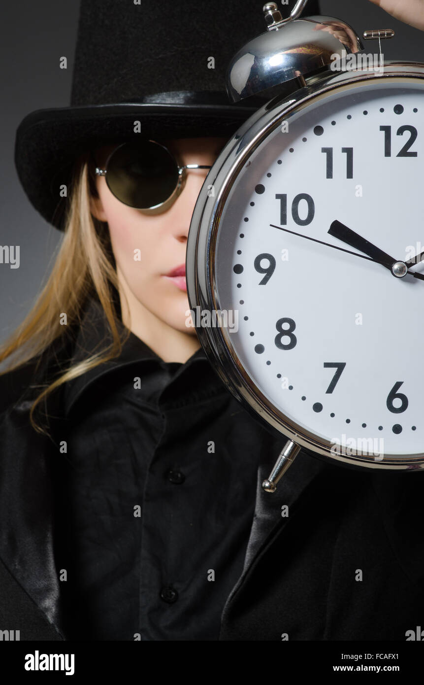 Woman with clock in business concept Stock Photo - Alamy