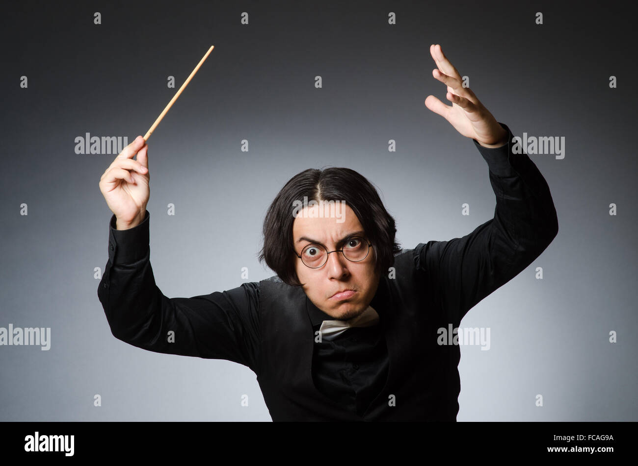 Funny conductor in musical concept Stock Photo - Alamy