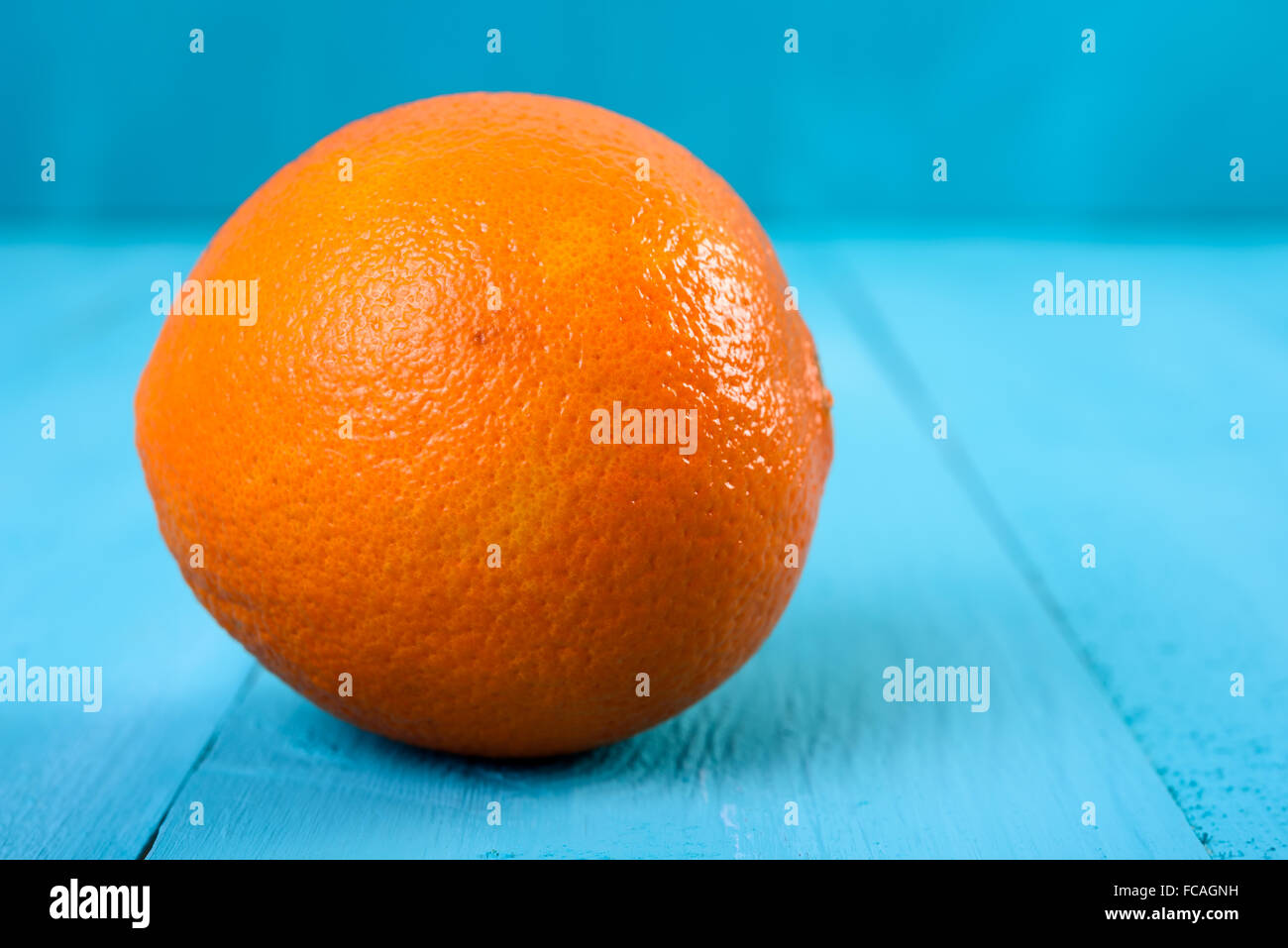 Orange Fruit On Turquoise Background Stock Photo - Alamy