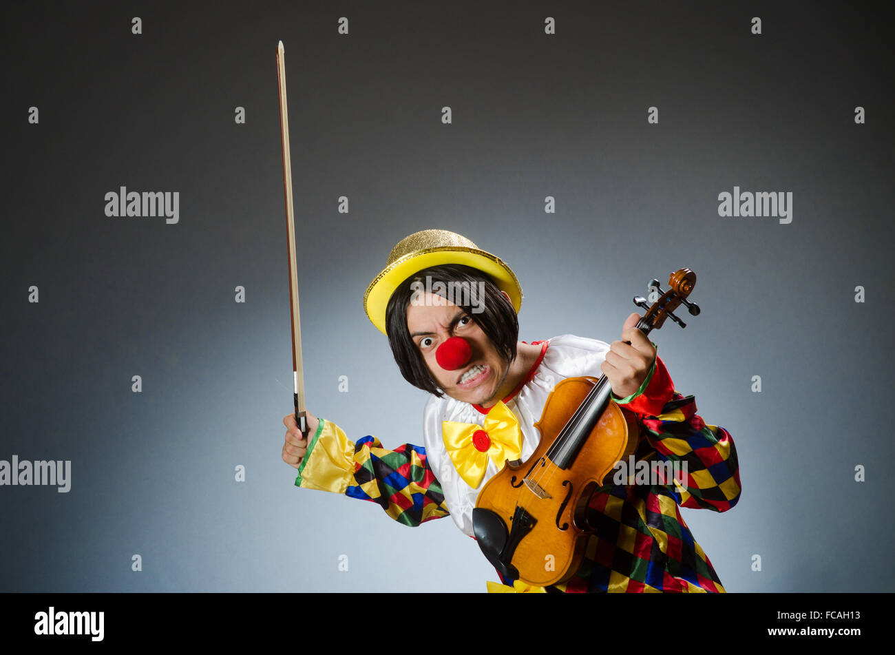 Funny violin clown player in musical concept Stock Photo - Alamy