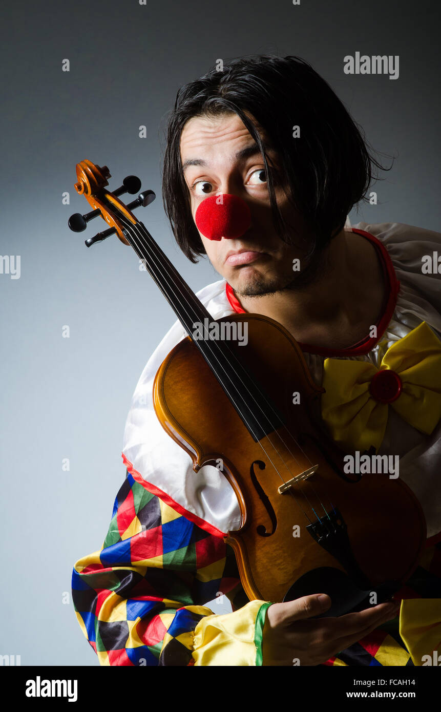 Funny violin clown player in musical concept Stock Photo - Alamy