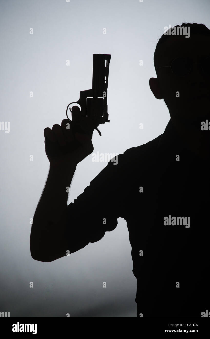 Shadow of the man with gun Stock Photo - Alamy