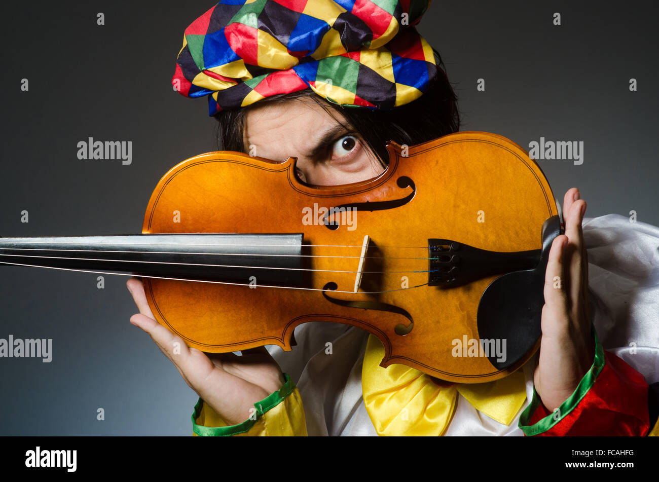 Funny violin clown player in musical concept Stock Photo - Alamy