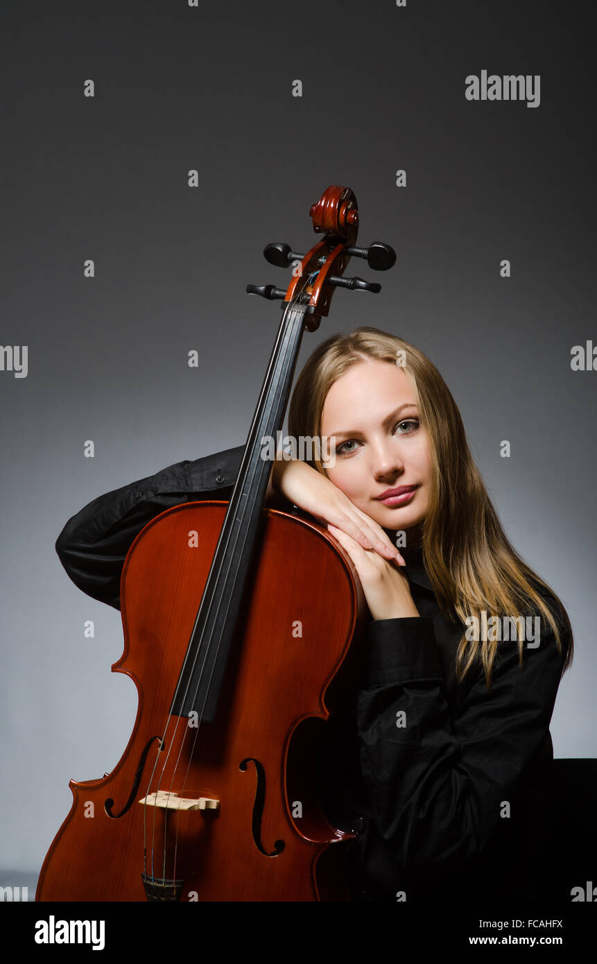 Woman playing classical cello in music concept Stock Photo - Alamy