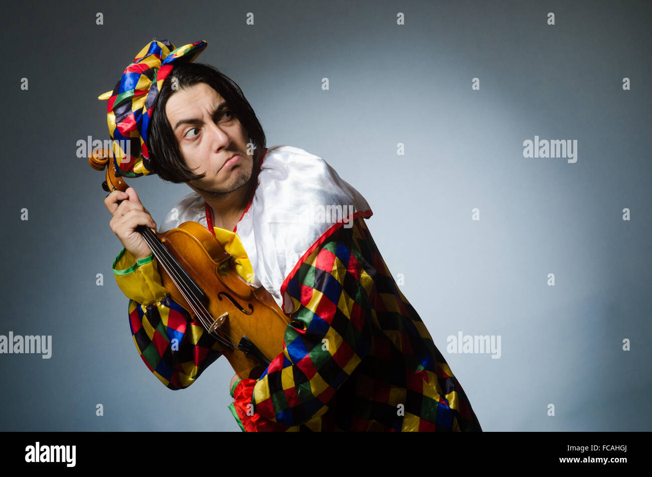 Funny violin clown player in musical concept Stock Photo - Alamy