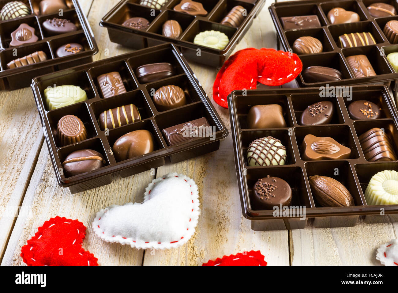 Assorted chocolates on wood table Stock Photo - Alamy