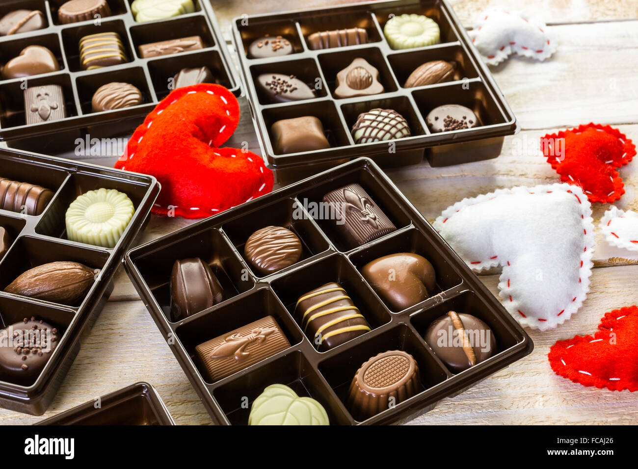 Assorted chocolates on wood table Stock Photo - Alamy