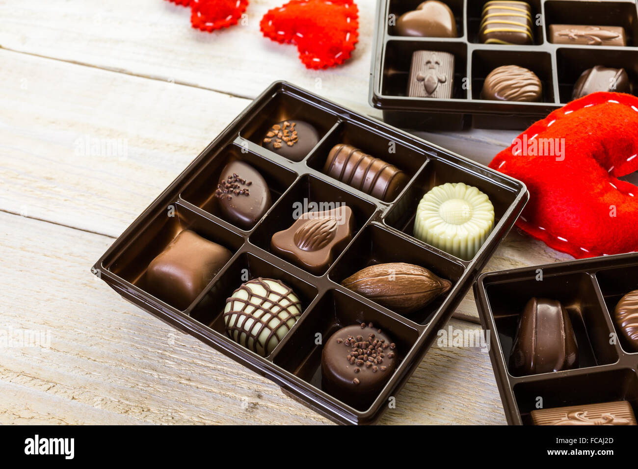 Assorted chocolates on wood table Stock Photo - Alamy