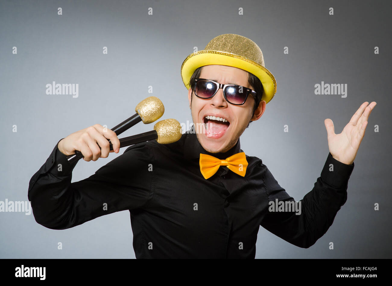 Funny man with mic in karaoke concept Stock Photo - Alamy