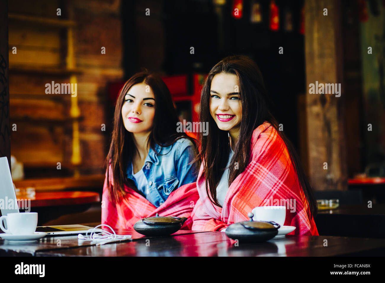 two girls watching something in laptop Stock Photo - Alamy