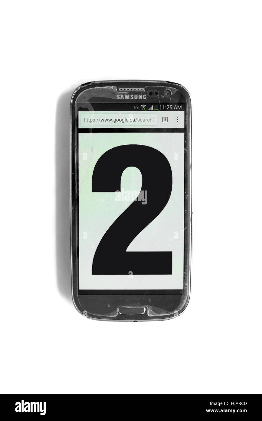 2 on the screen of smartphones photographed against a white background ...