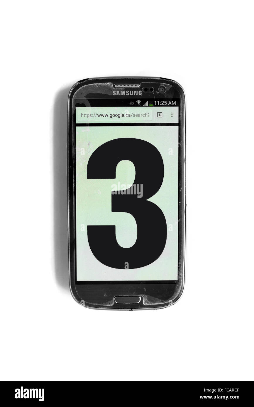 3 on the screen of smartphones photographed against a white background ...