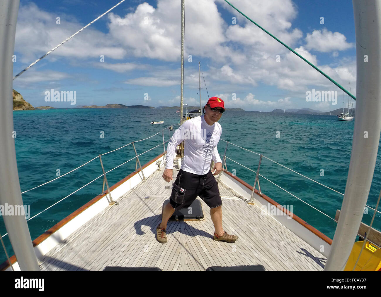 A man walking on the foredeck of a sailboat Stock Photo - Alamy