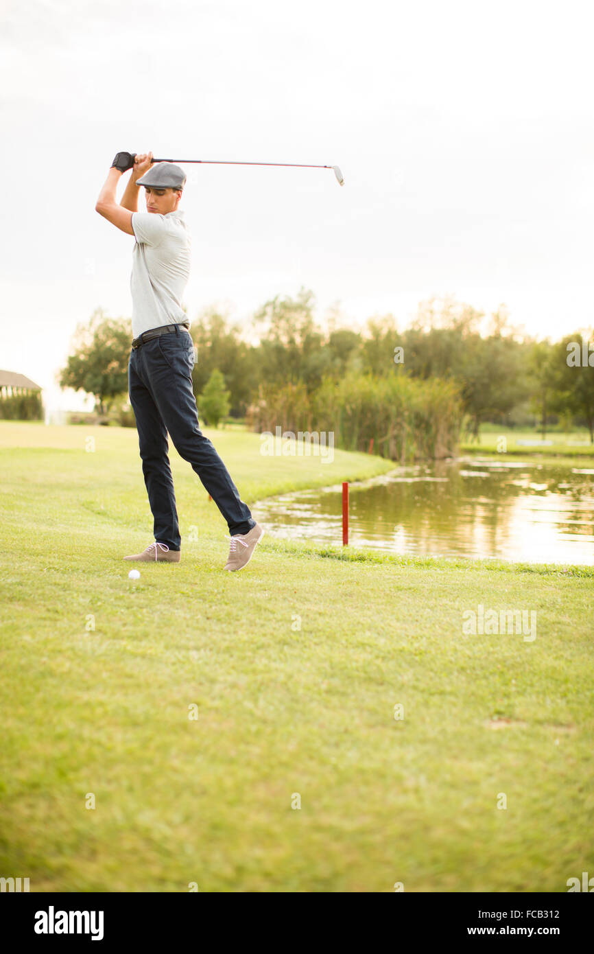 Young man playing golf Stock Photo - Alamy