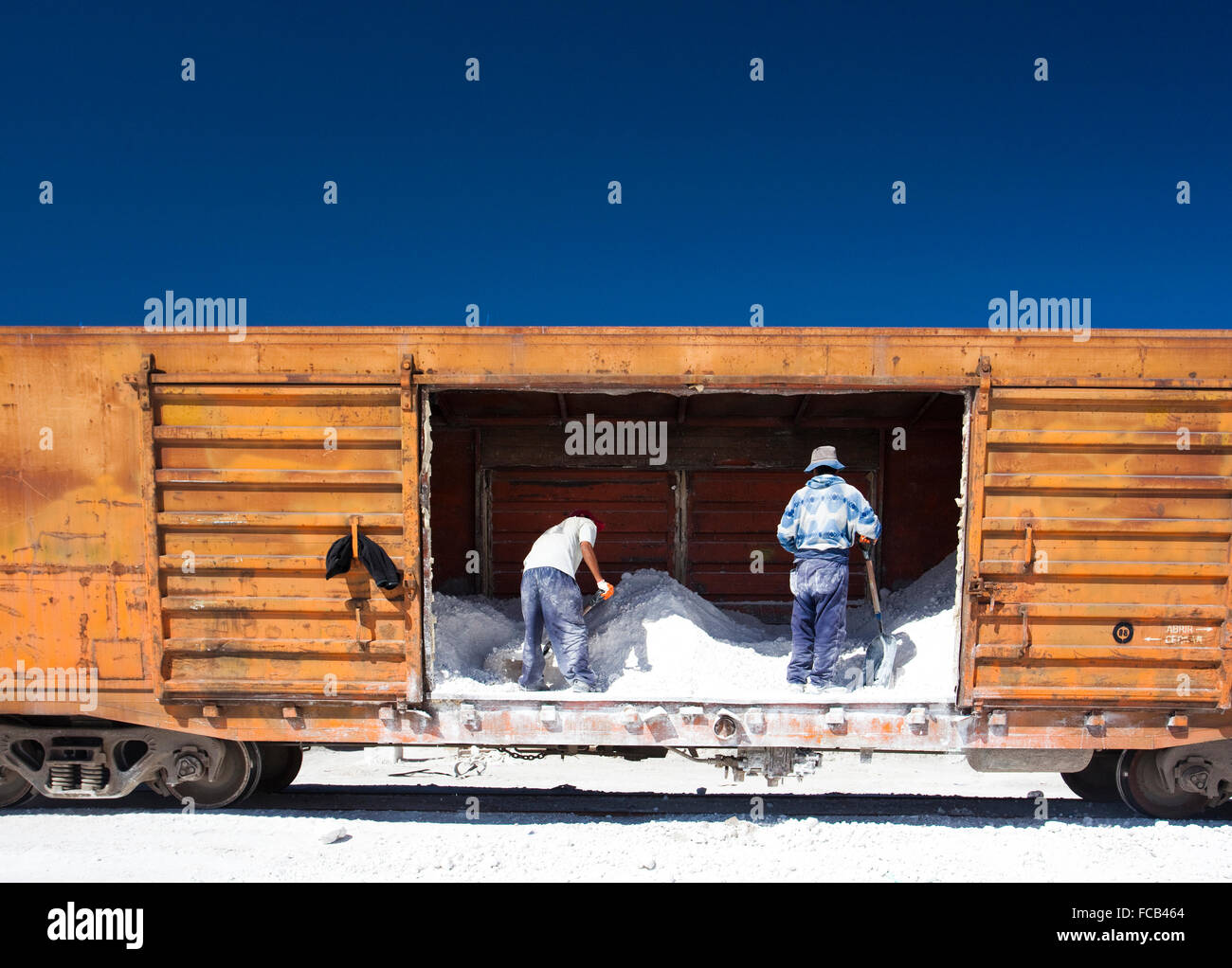 workers load salt into trains in the Salar de Uyuni, Bolivia, the ...