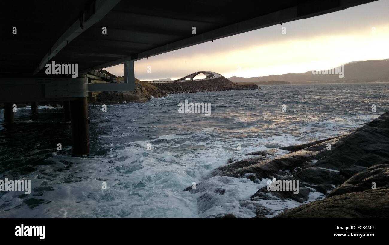 River Flowing Under Bridge At Dusk Stock Photo - Alamy