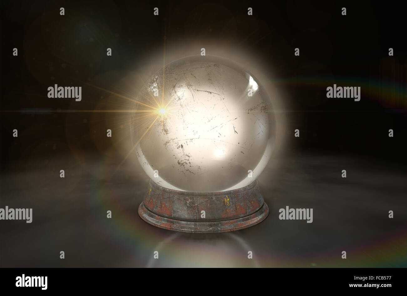 A regular glowing crystal ball on an isolated dark studio background ...