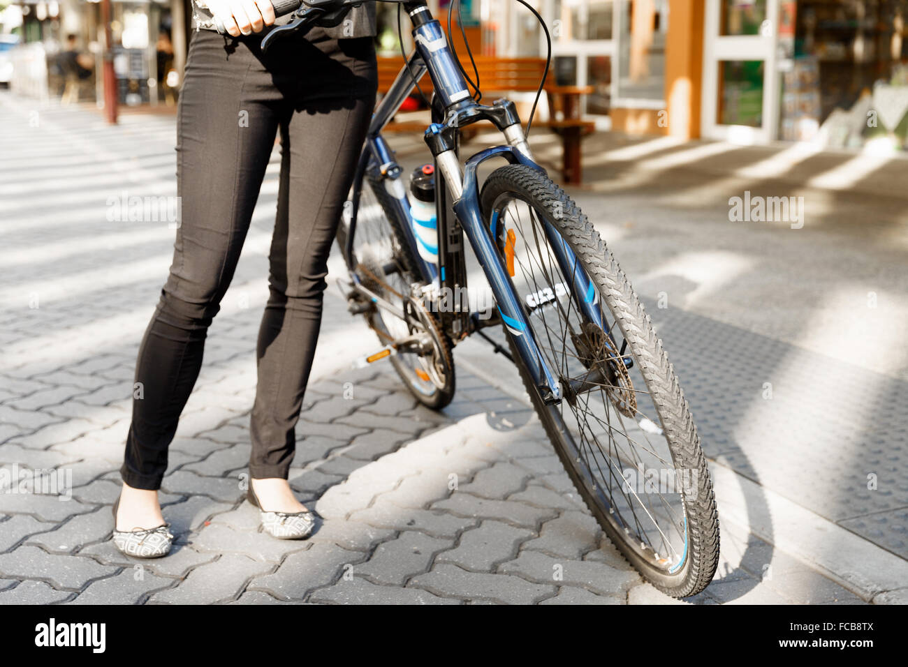 Woman riding bike legs up hi-res stock photography and images - Alamy