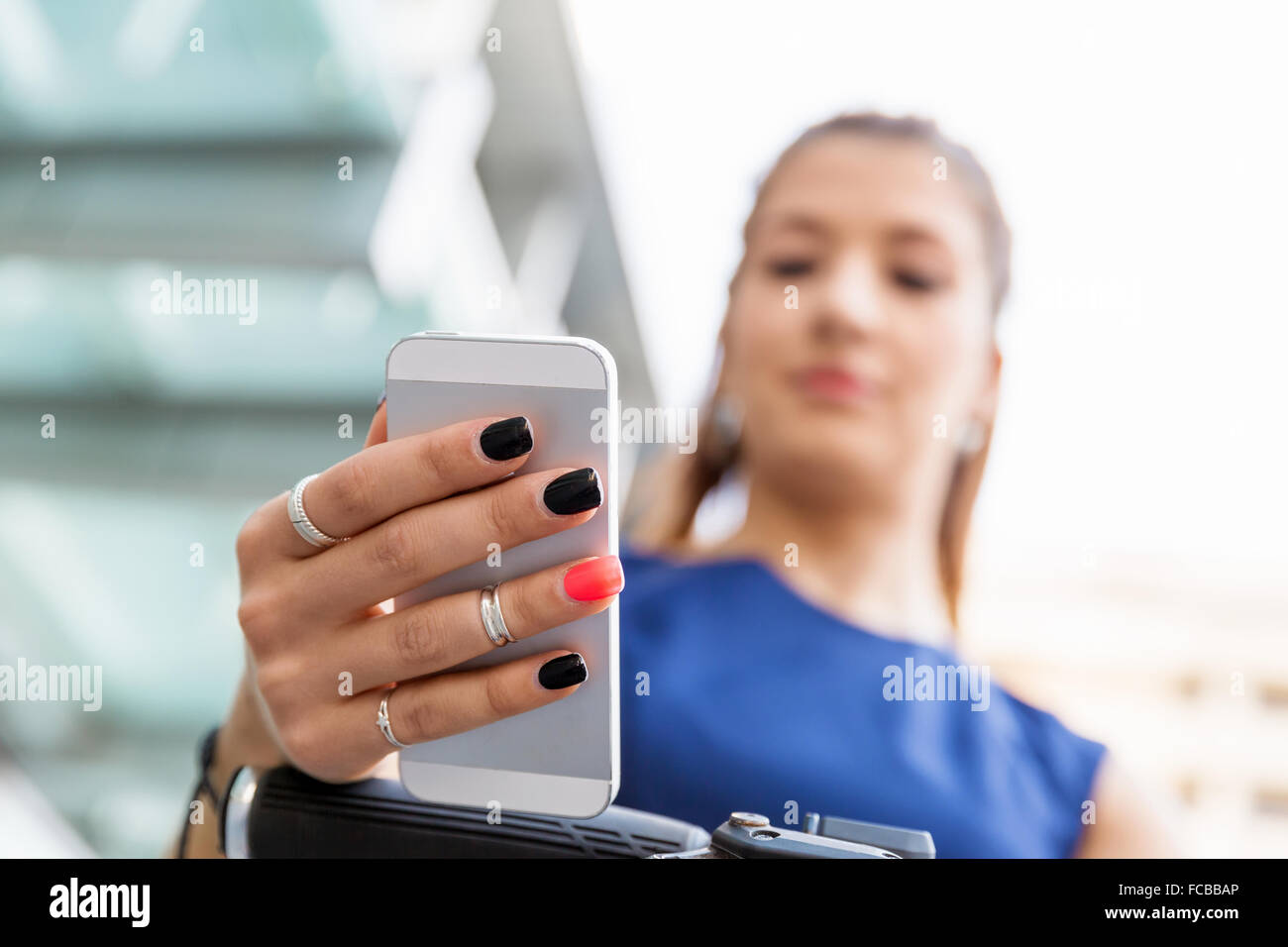 Business woman in a street using her smart phone Stock Photo - Alamy